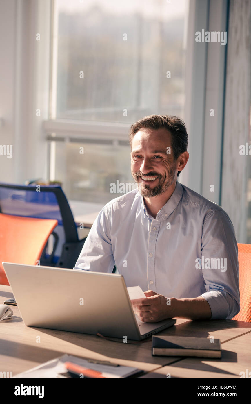 Businessman in office interior Stock Photo - Alamy