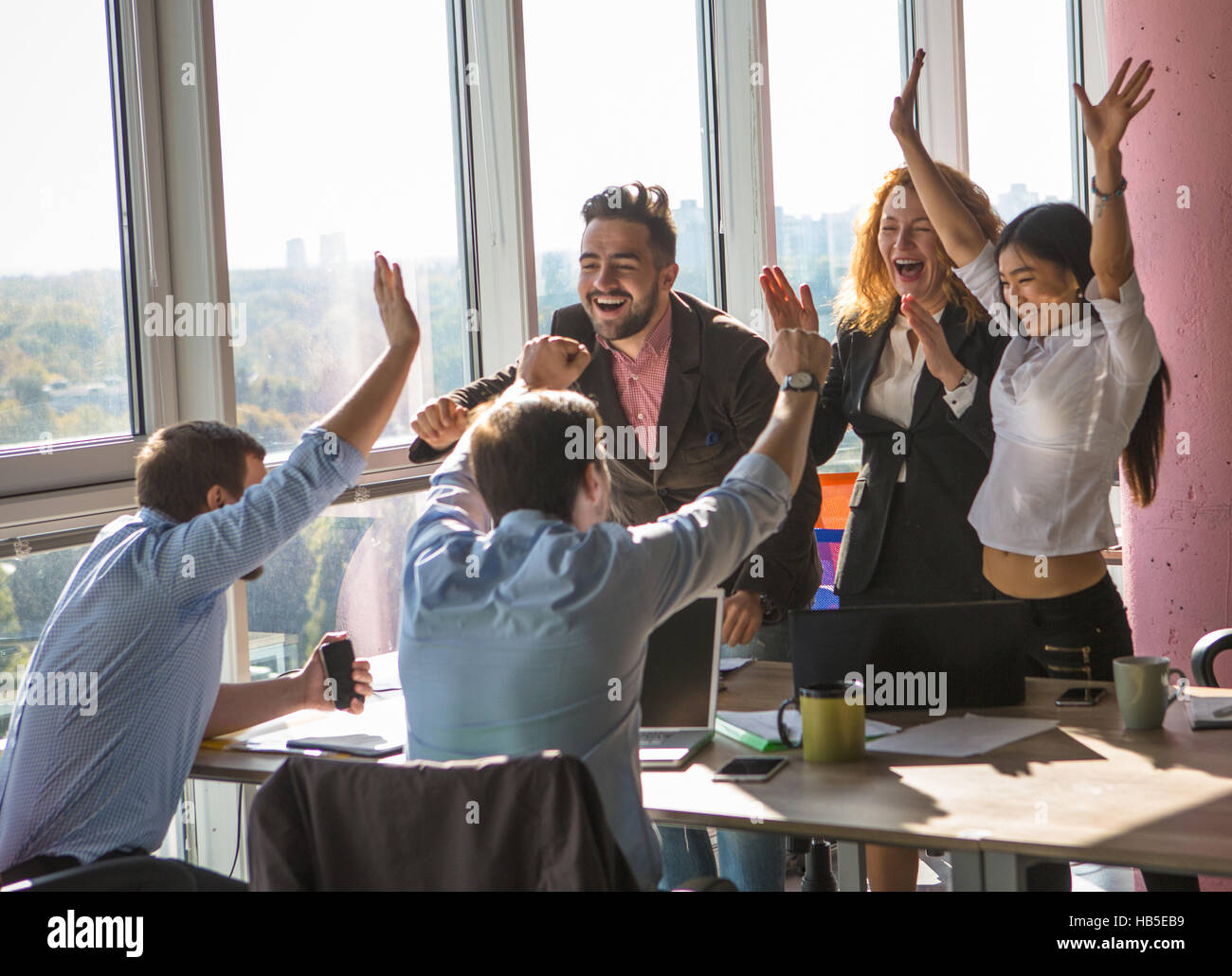 Business people showing team work in office Stock Photo - Alamy