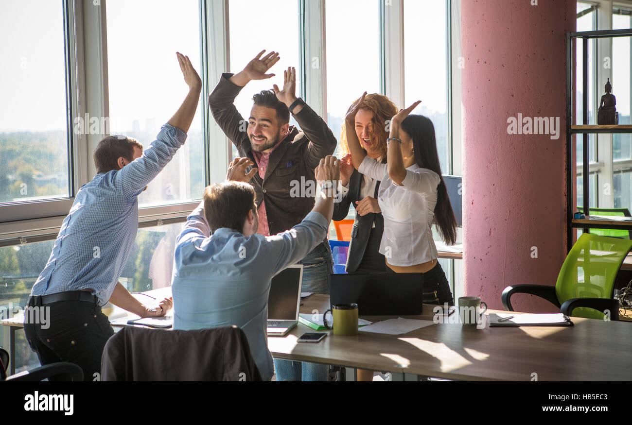 Business people showing team work in office Stock Photo - Alamy