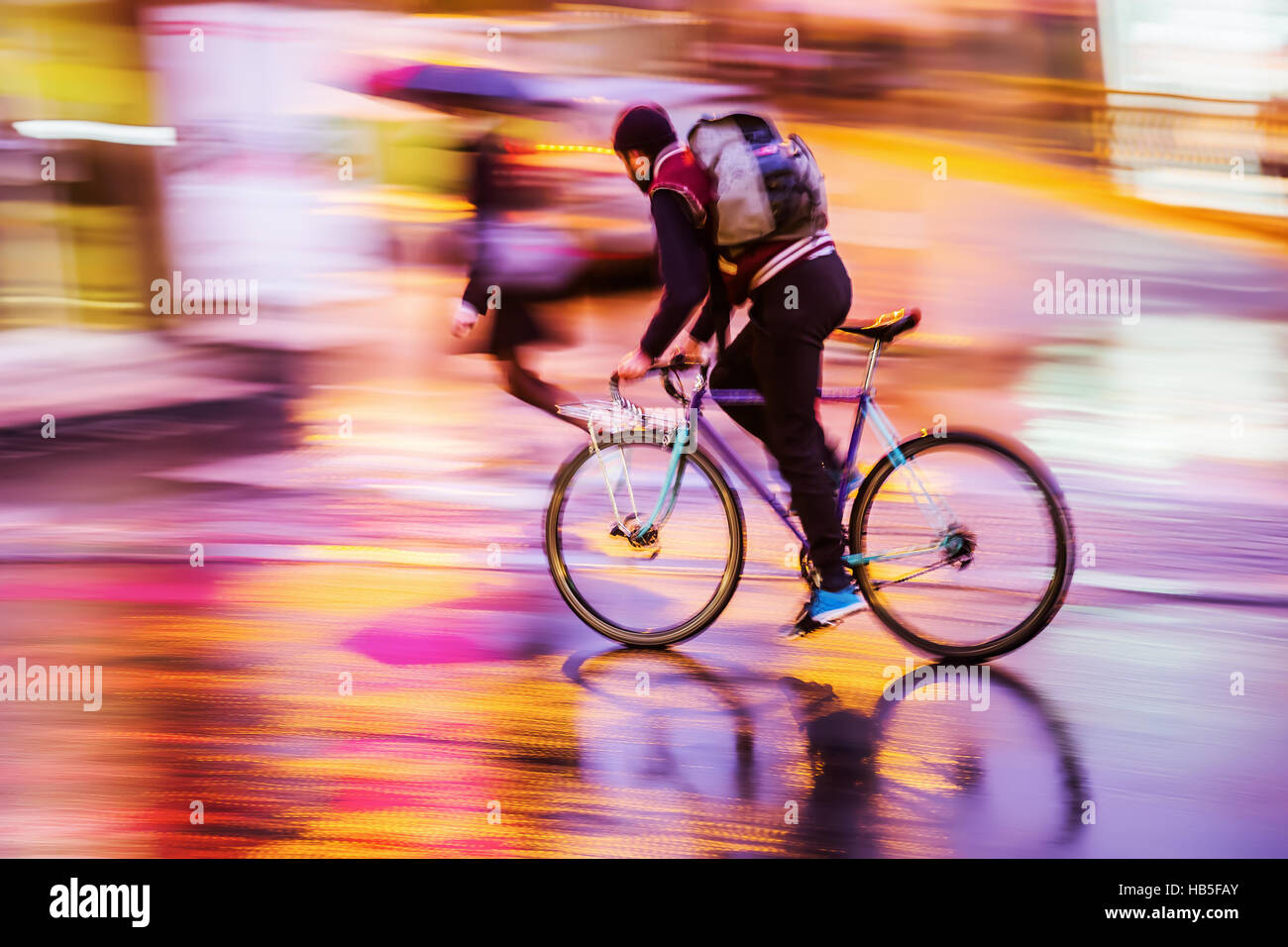 picture with camera made motion blur effect of a bicycle rider at night ...