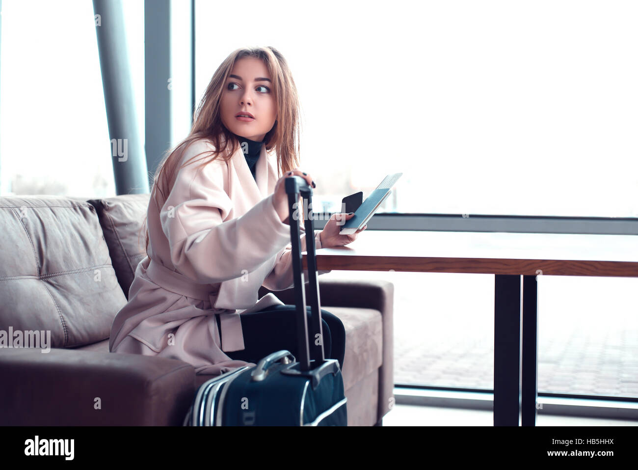 Woman sitting on the couch in a hall Stock Photo - Alamy