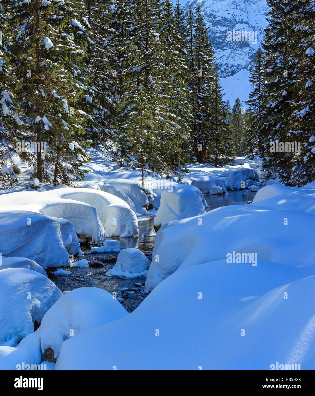 Small mountain stream with snowdrifts Stock Photo - Alamy