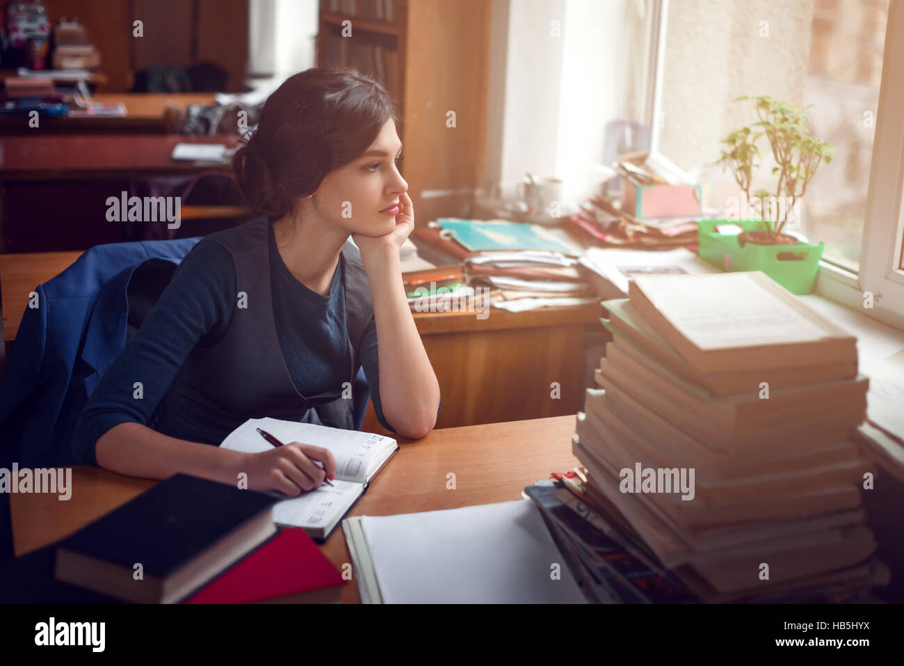 Serious woman thinking in library silence Stock Photo - Alamy