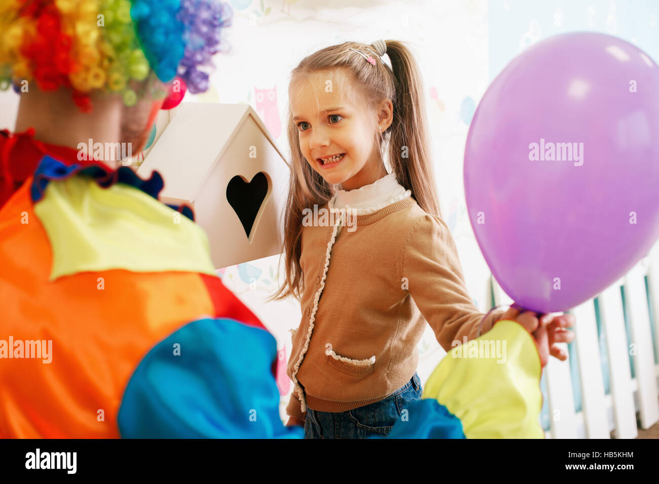 Entertainment with clown in colourful costume Stock Photo - Alamy