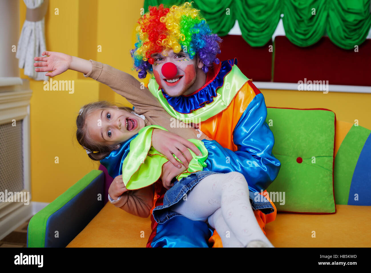 Celebrating birthday party with funny clown Stock Photo - Alamy