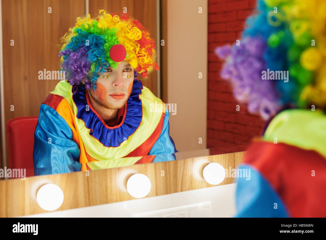 Circus clown looks in a mirror in makeup room Stock Photo - Alamy