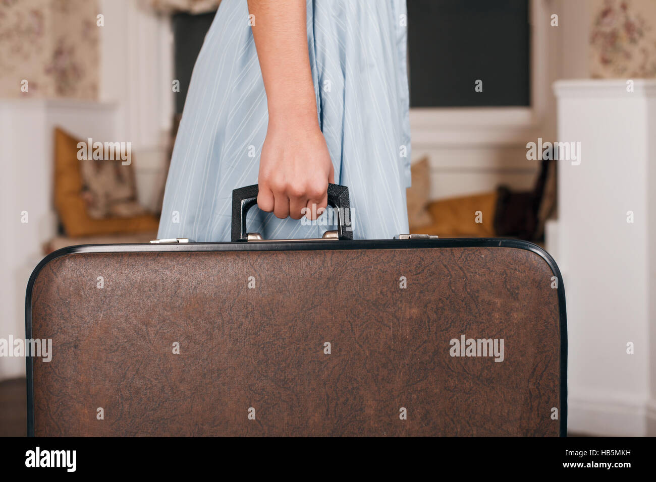 Female hand holding suitcase Stock Photo - Alamy