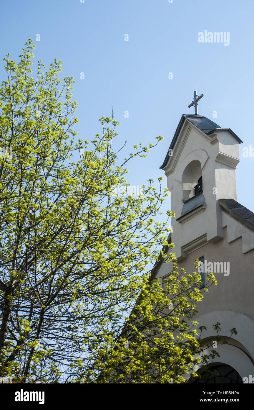 Catholic Church and blossomed tree Stock Photo - Alamy