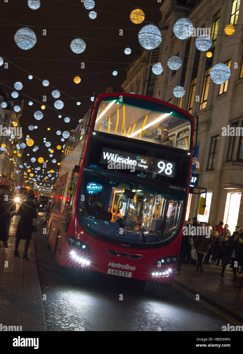 A 98 bus to Willesden navigates busy Oxford Street, London, during ...