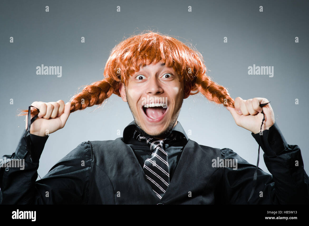 Funny man with red hair wig Stock Photo - Alamy