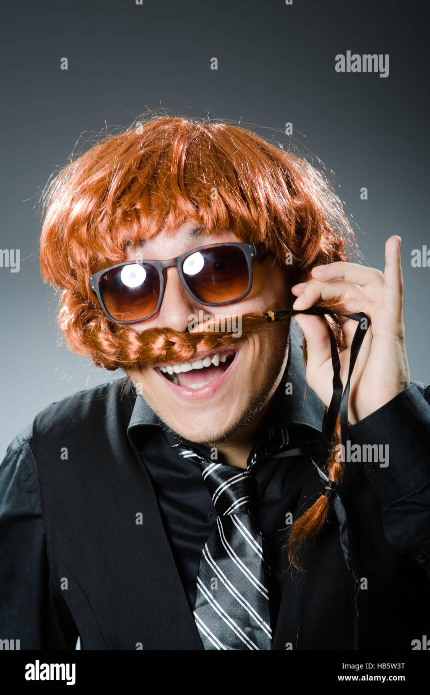 Funny man with red hair wig Stock Photo - Alamy