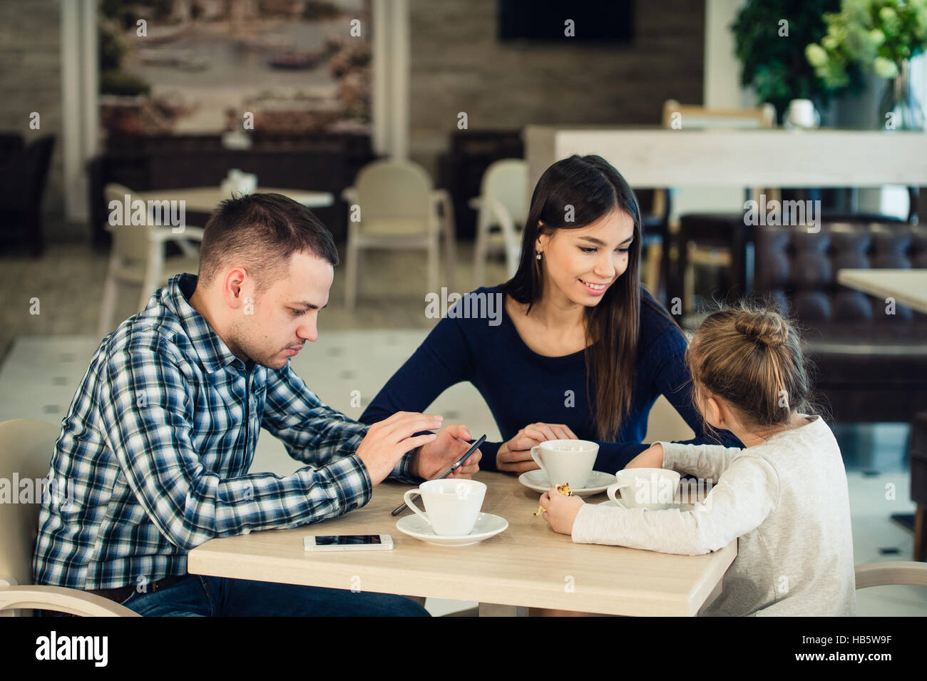 Family Enjoying tea In Cafe Together Stock Photo - Alamy