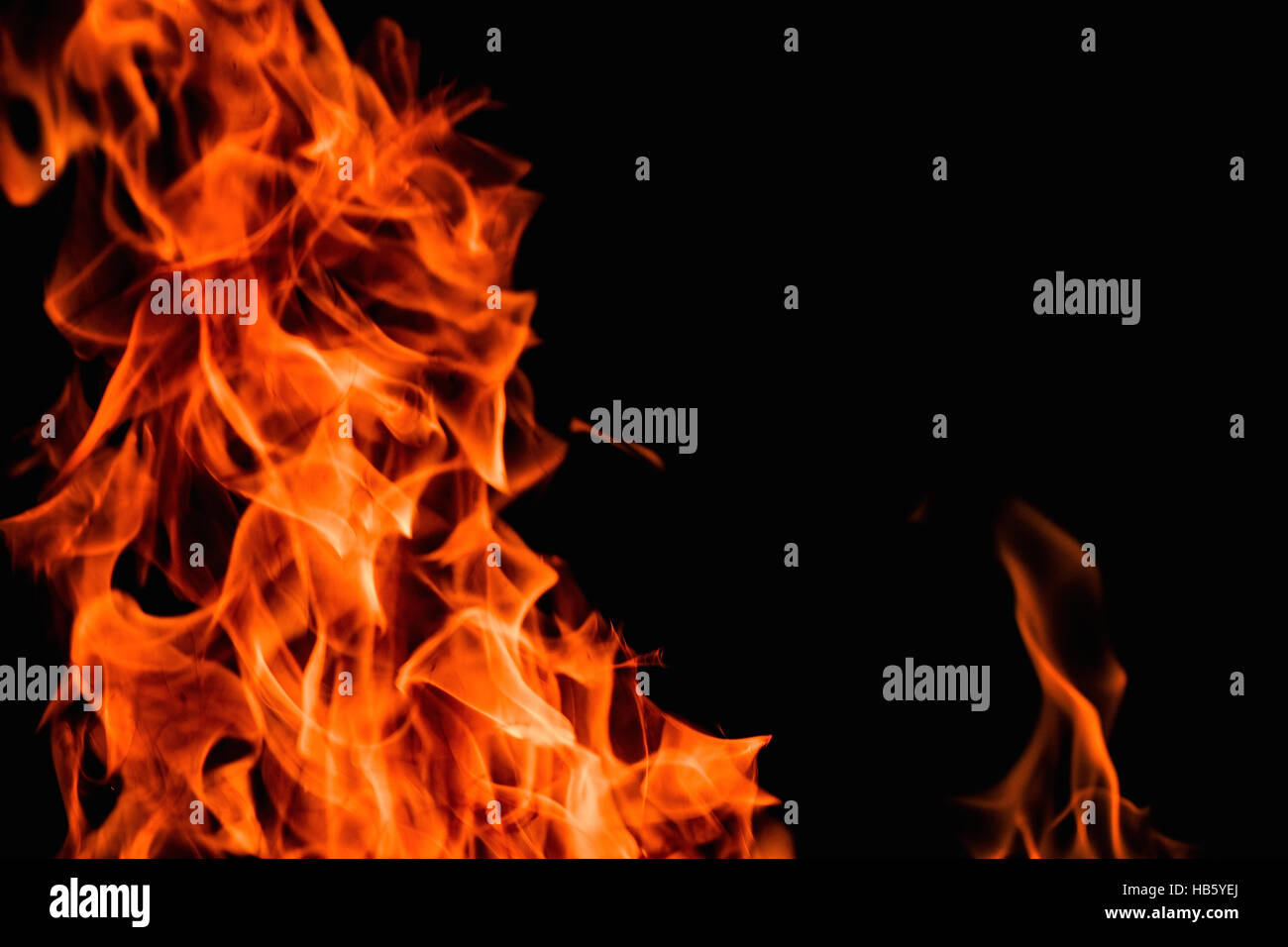 raging flames red fire black background Stock Photo - Alamy