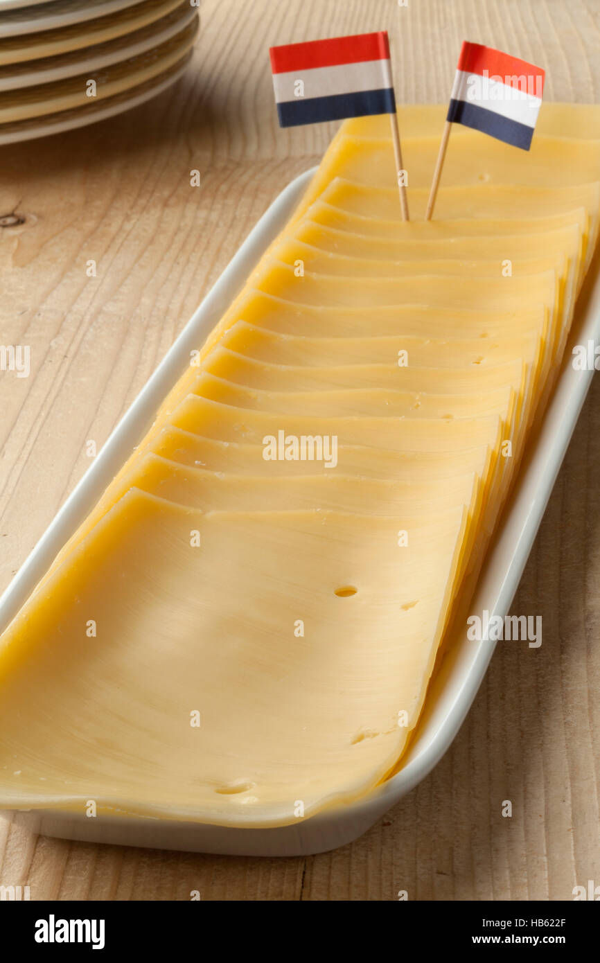 Dish with slices of Gouda cheese and dutch flags Stock Photo - Alamy