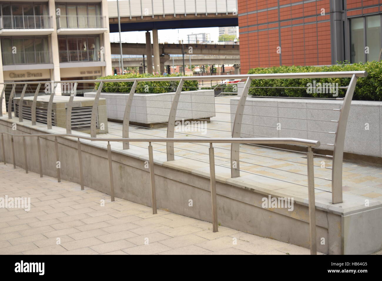 Long silver railing leading the street Stock Photo - Alamy