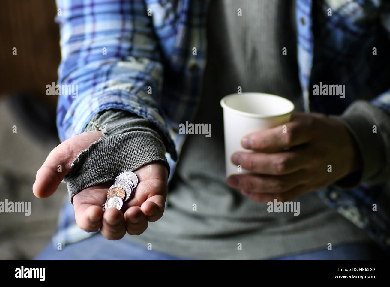 homeless man hand help Stock Photo - Alamy