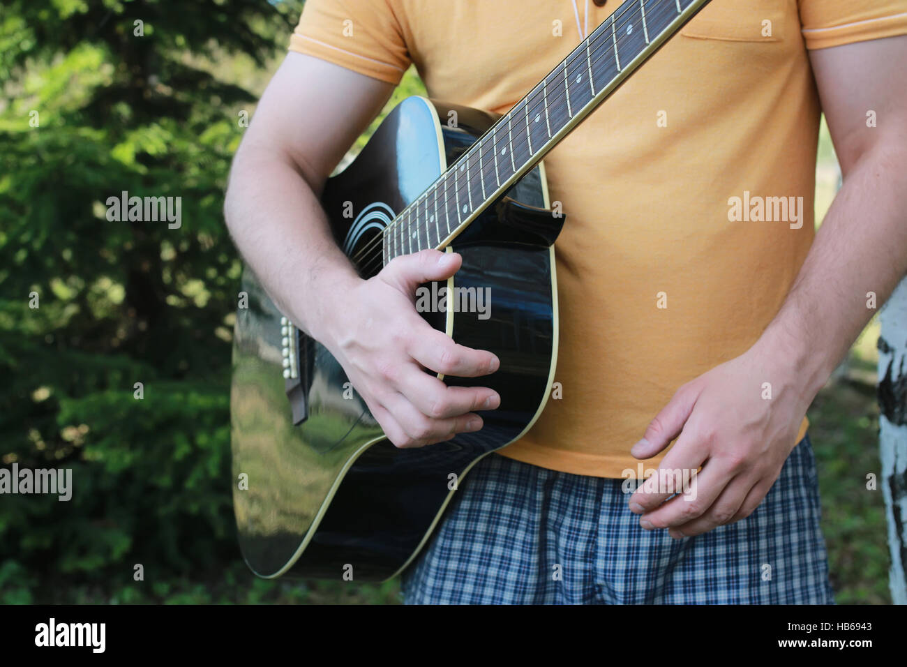 guitar string man hand outdoor Stock Photo - Alamy