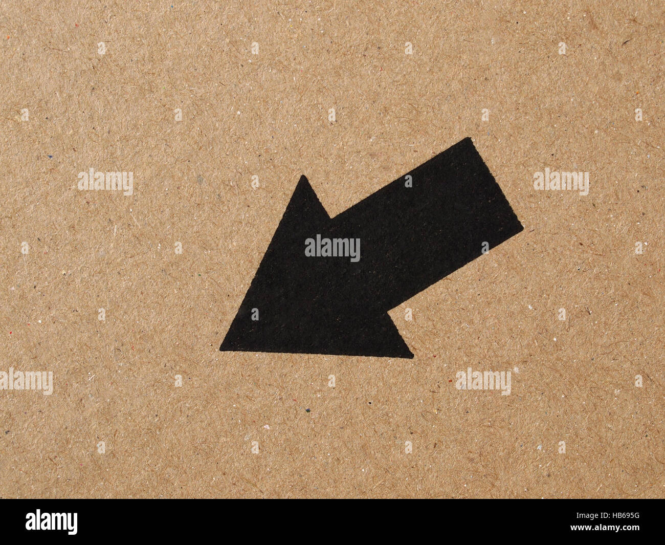 Black arrow on cardboard Stock Photo - Alamy