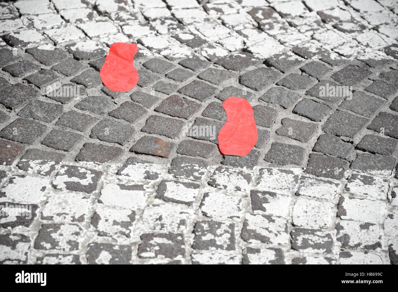 red footsteps in town Stock Photo - Alamy