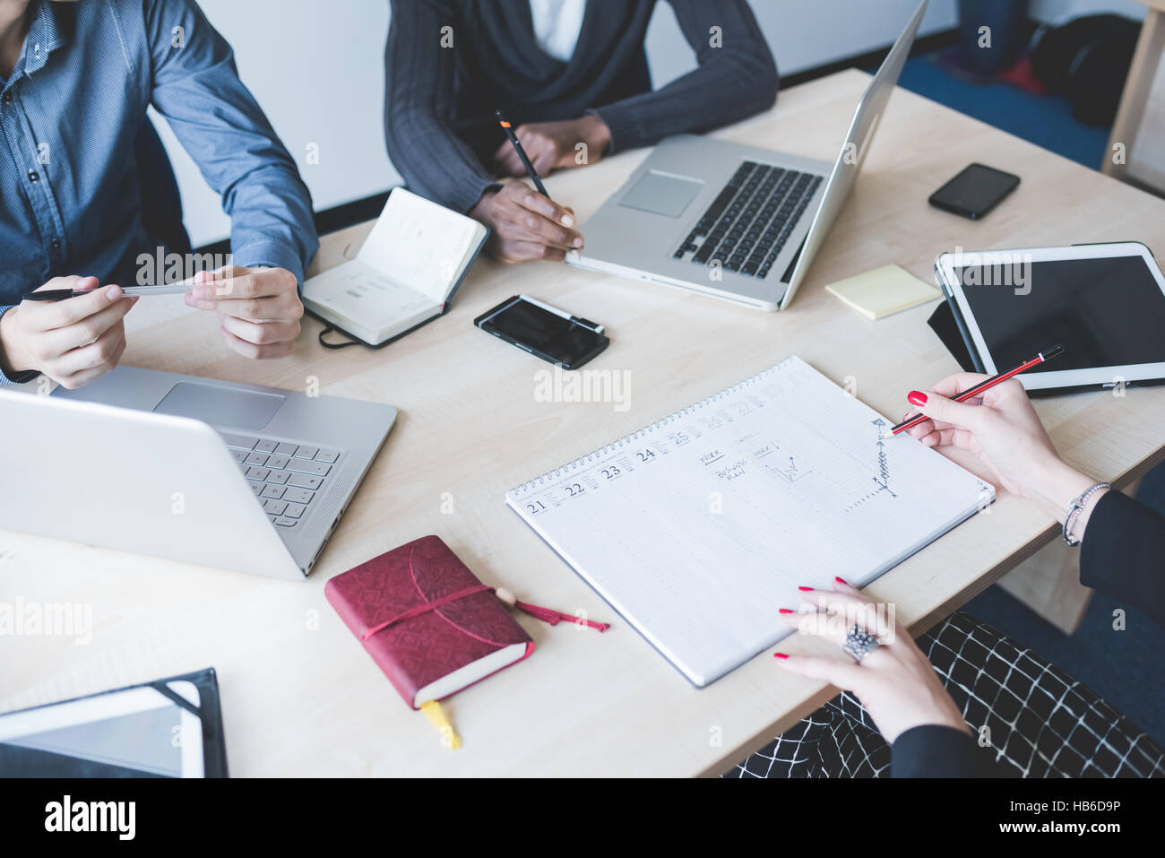 Top view of an office desk with a group of people working using ...