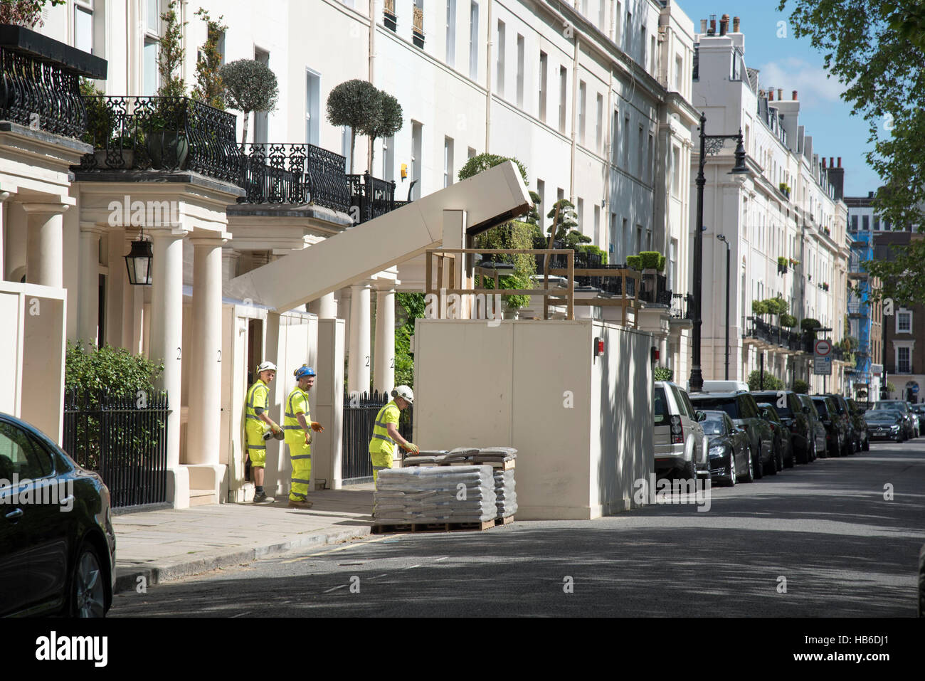 Basement digging shoot for skip waste rubble in posh house white stucco ...