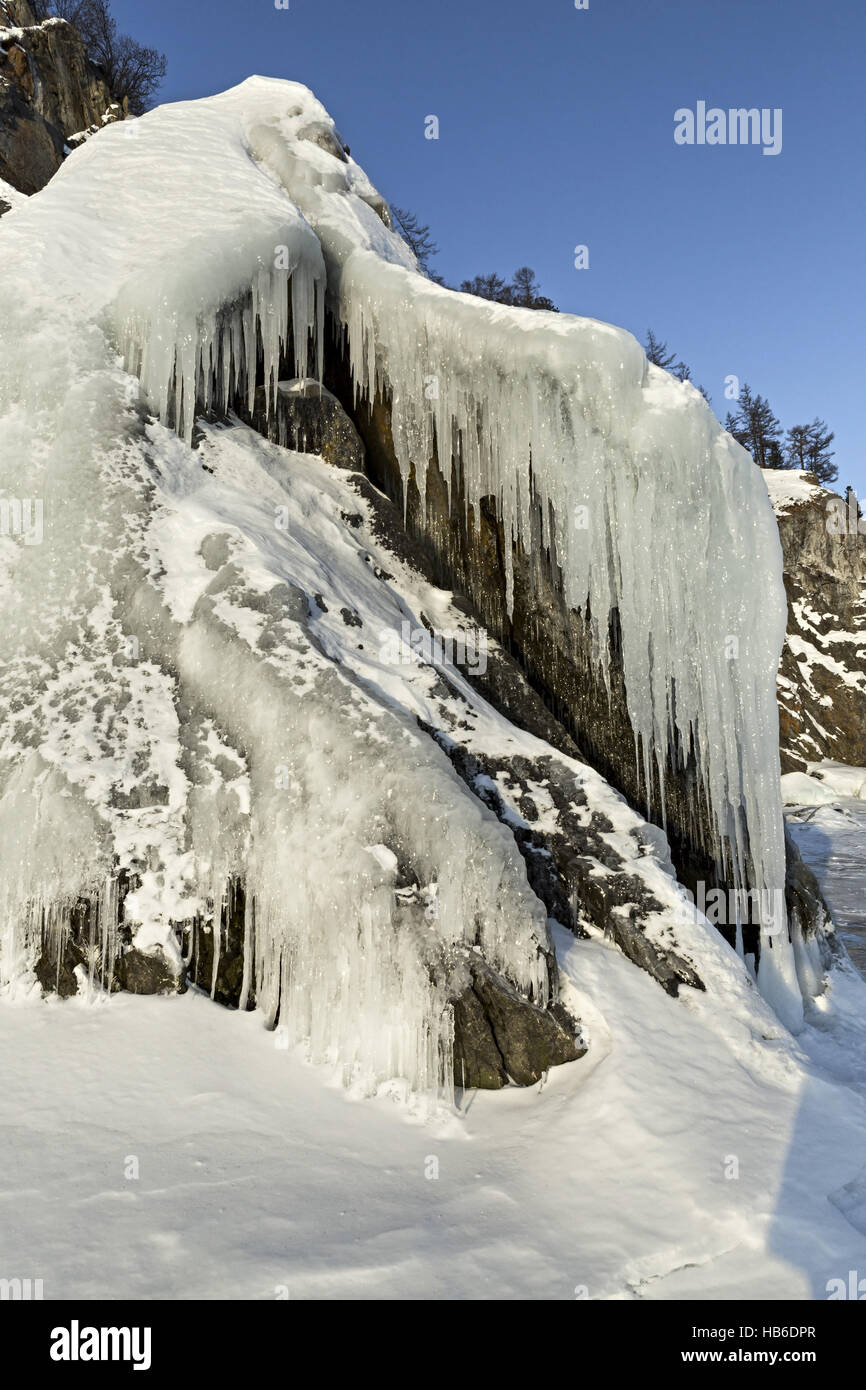 Huge icicles on rocks Stock Photo - Alamy