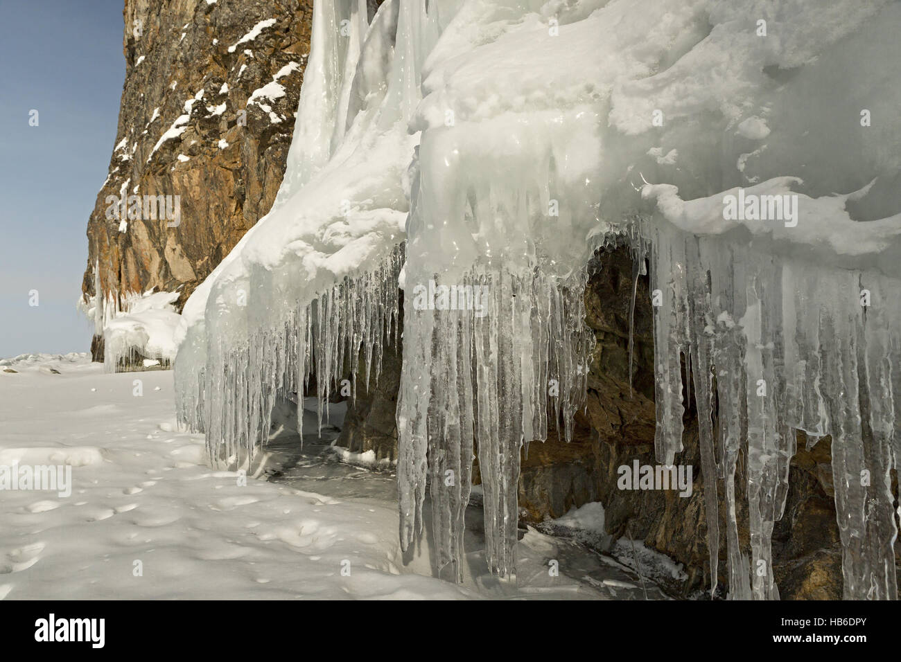 Huge icicles on rocks Stock Photo - Alamy