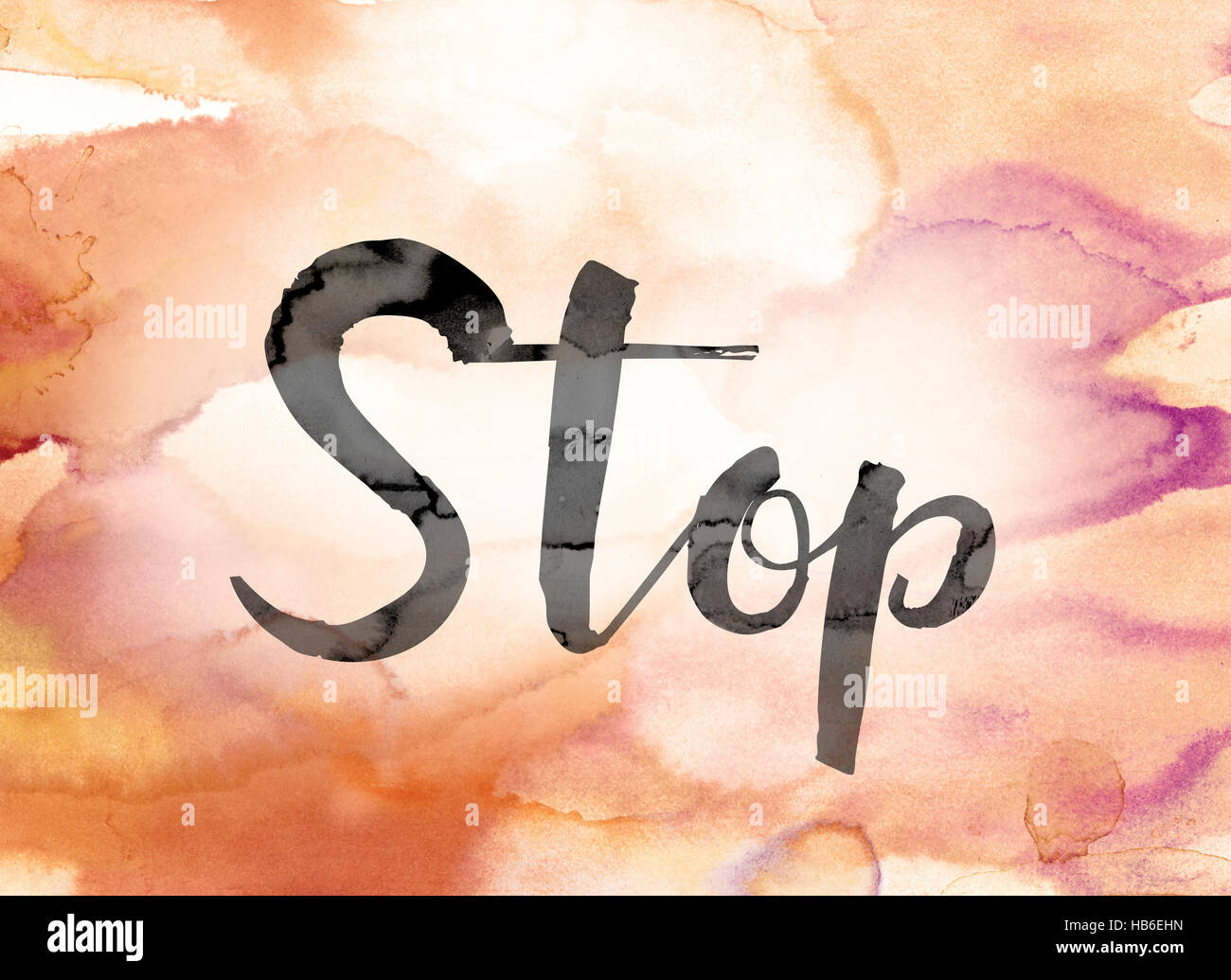 The word "Stop" painted in black ink over a colorful watercolor washed ...