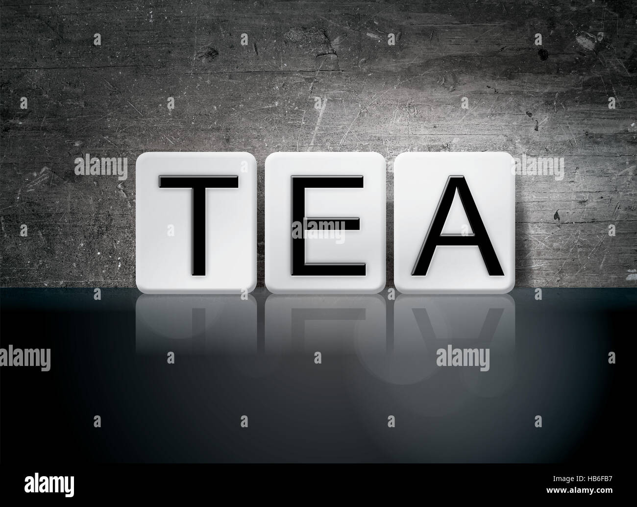 The word "Tea" written in white tiles against a dark vintage grunge ...