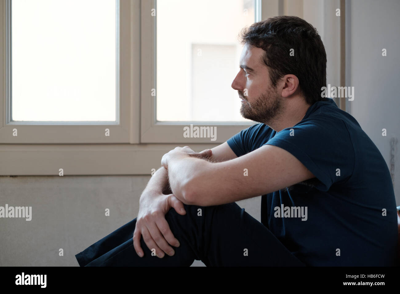 Sad man window hi-res stock photography and images - Alamy