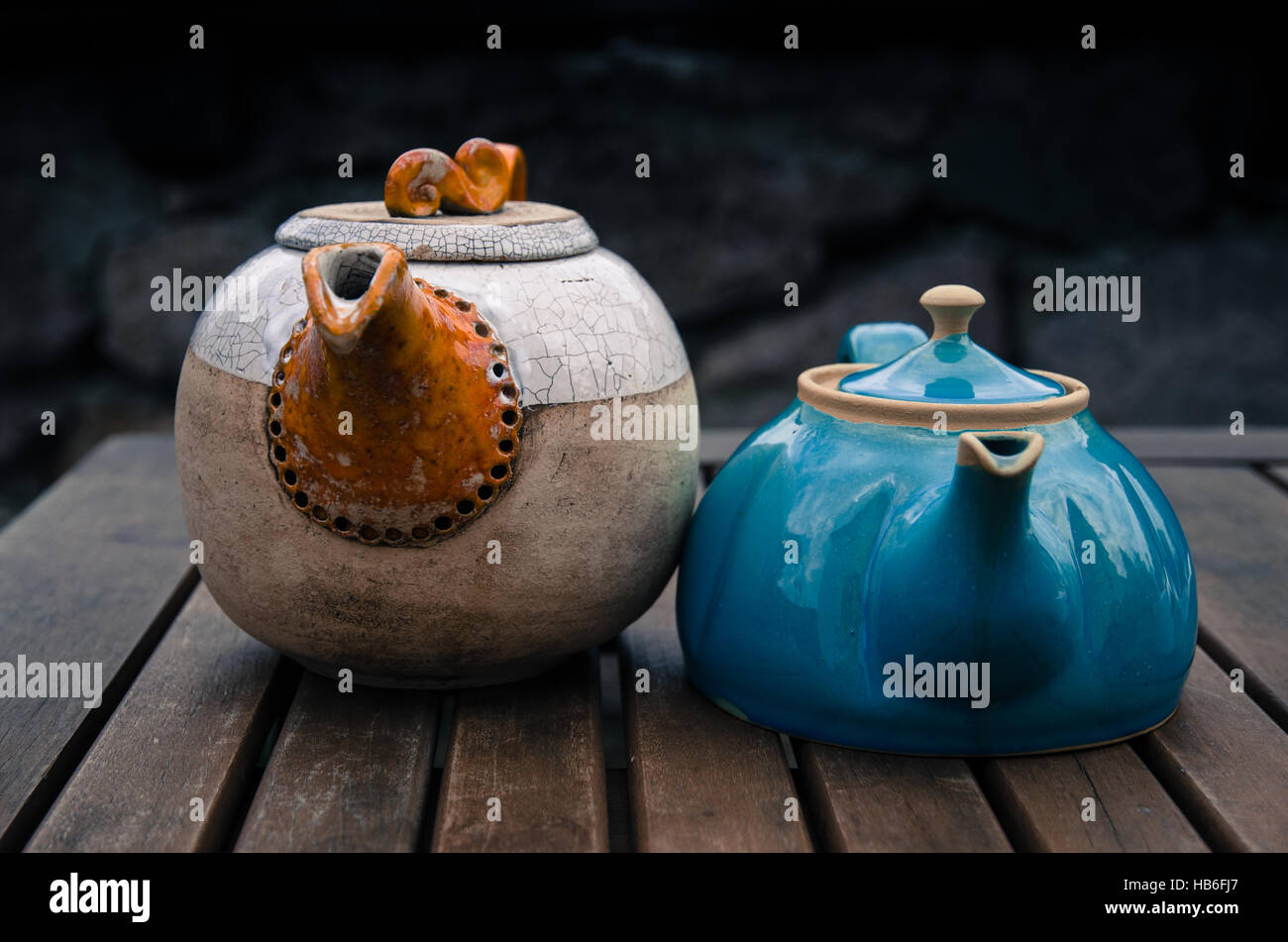 two ceramics teapots in wooden table Stock Photo - Alamy