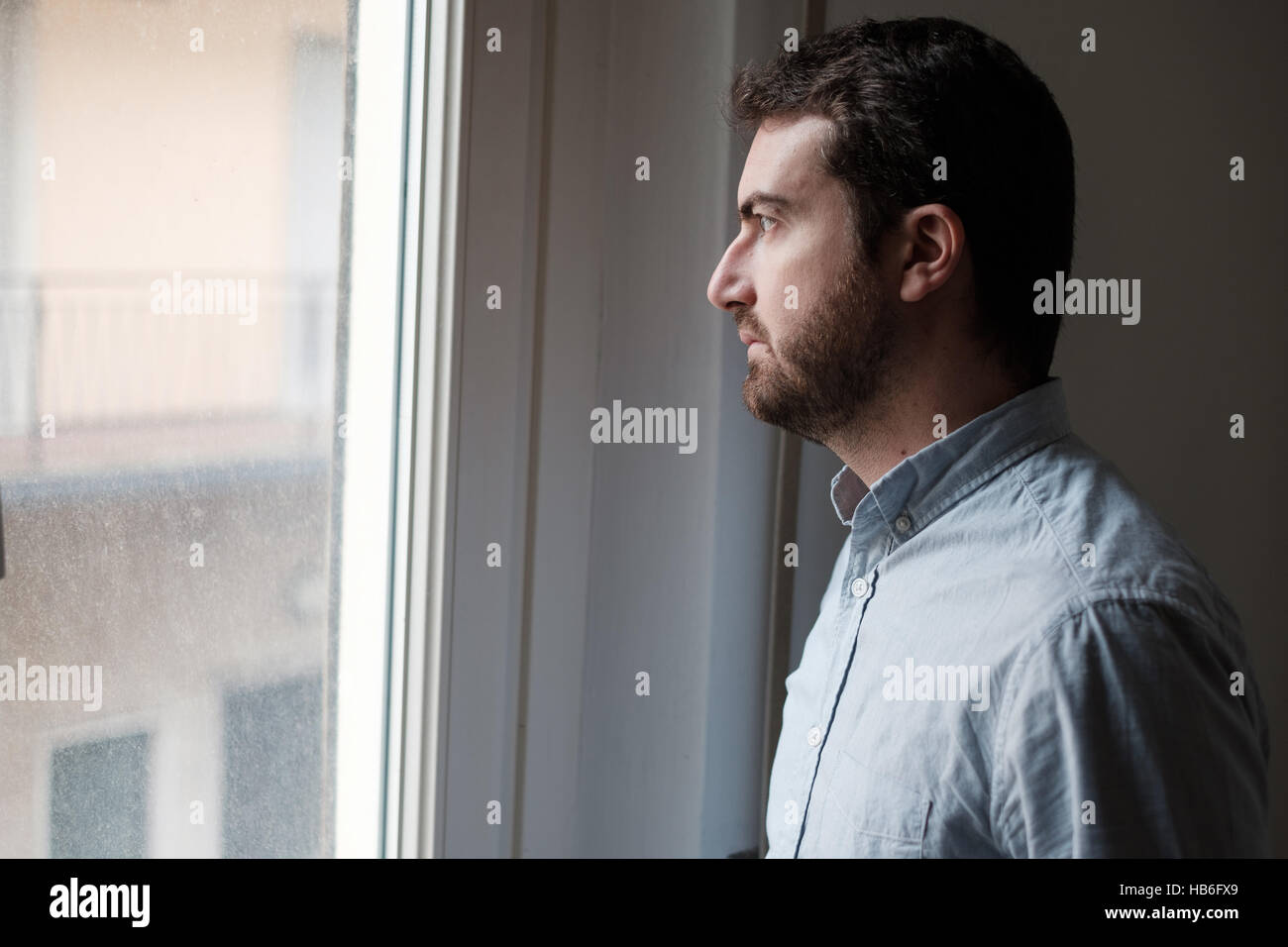Sad man window hi-res stock photography and images - Alamy