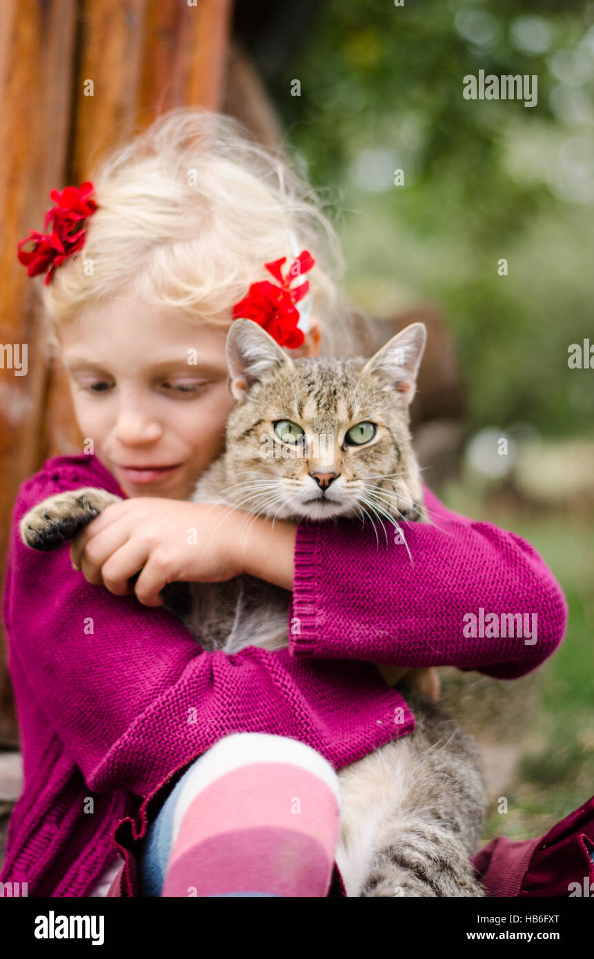 adorable caucasian blond kid holding domestic cat Stock Photo - Alamy