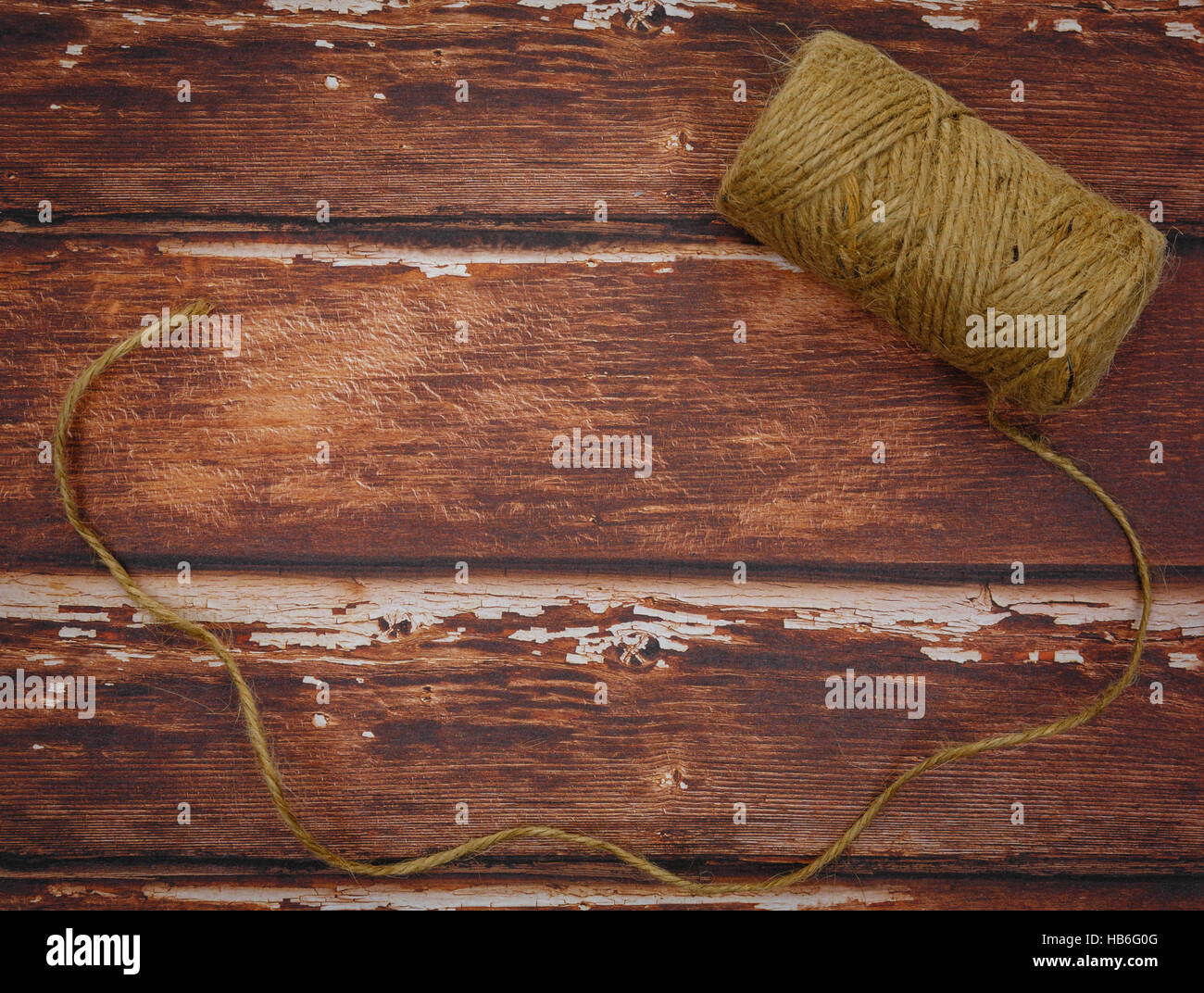 Rough thread reel on wood background Stock Photo - Alamy