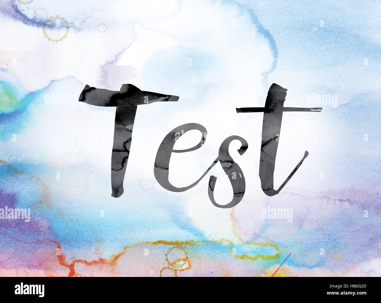 The word "Test" painted in black ink over a colorful watercolor washed ...