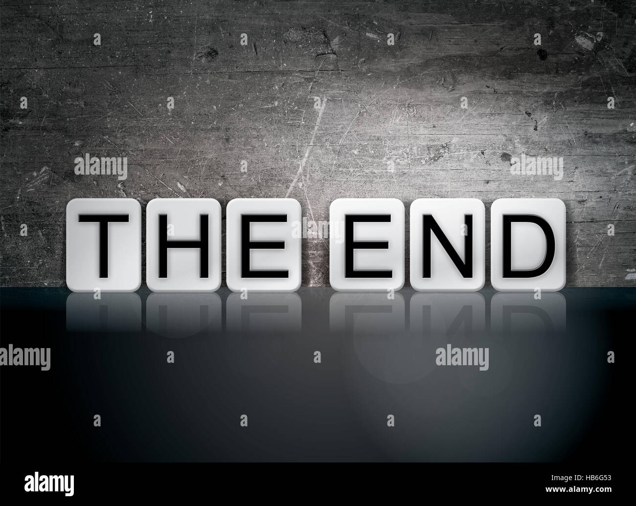 The word "The End" written in white tiles against a dark vintage grunge ...