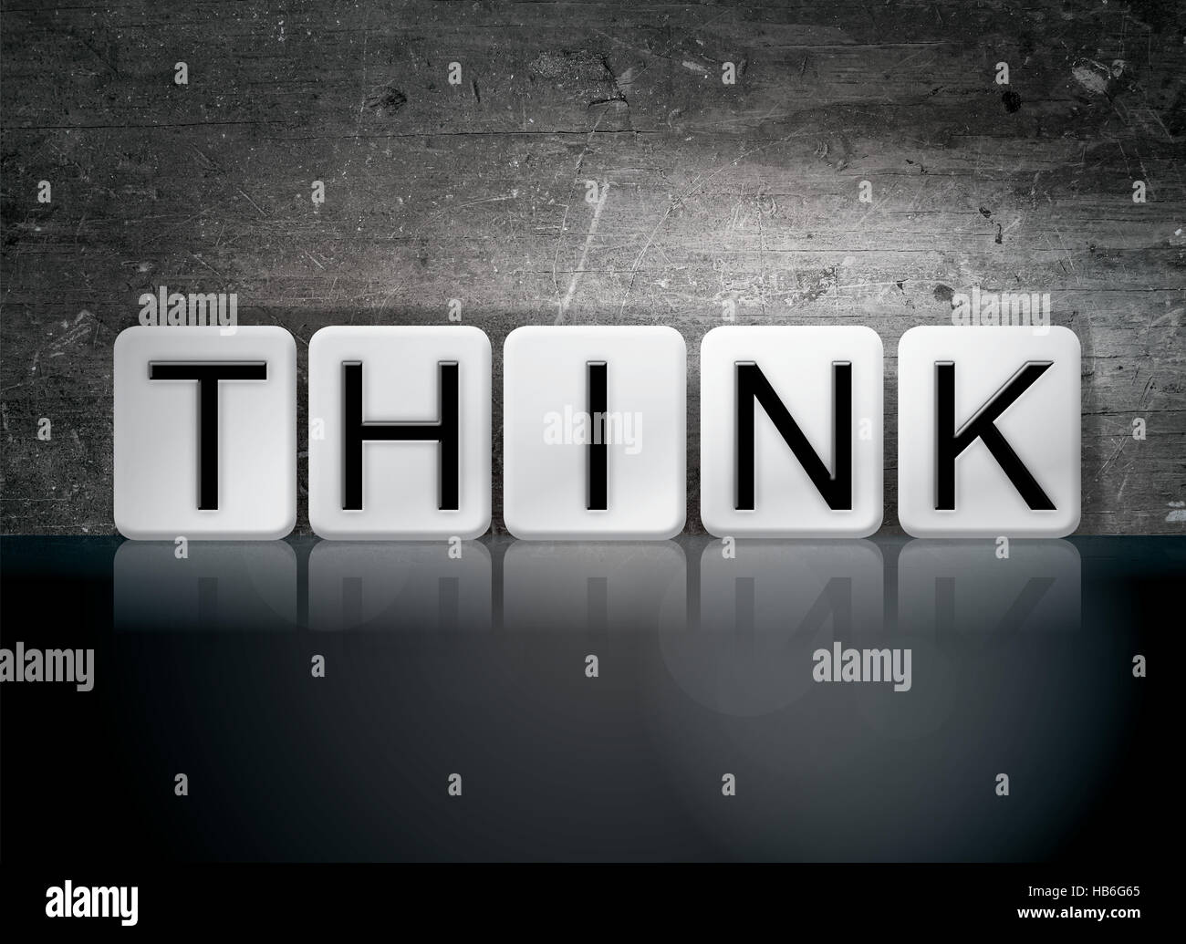 The word "Think" written in white tiles against a dark vintage grunge ...