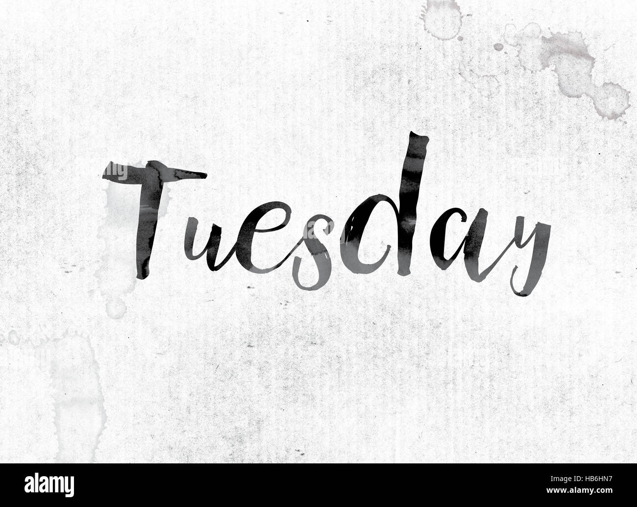 The word "Tuesday" concept and theme painted in watercolor ink on a ...