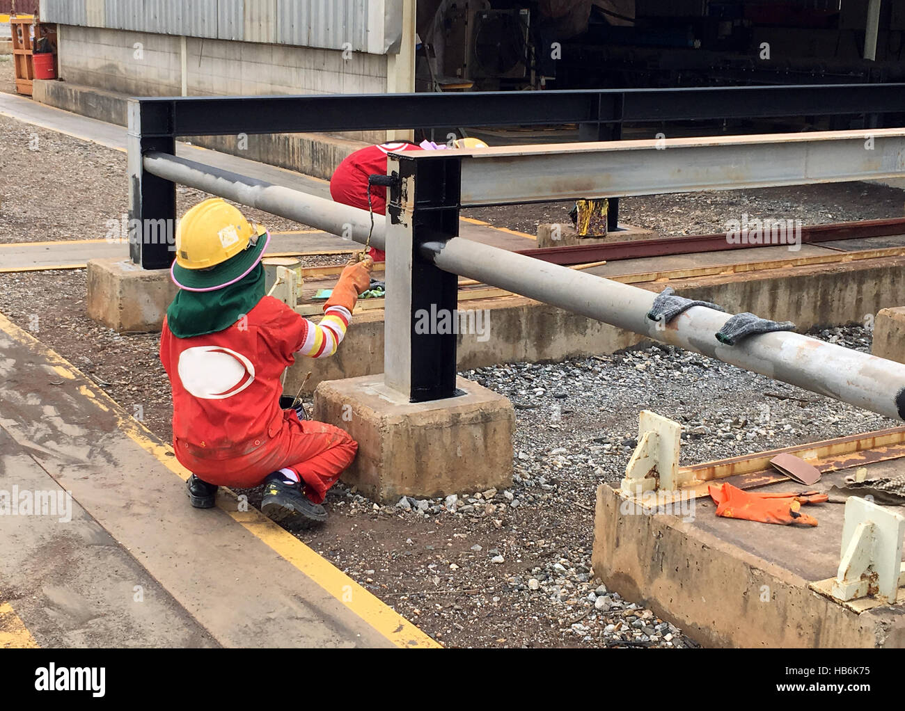 Technician paints Pipe work structural steel in oil and gas offshore ...