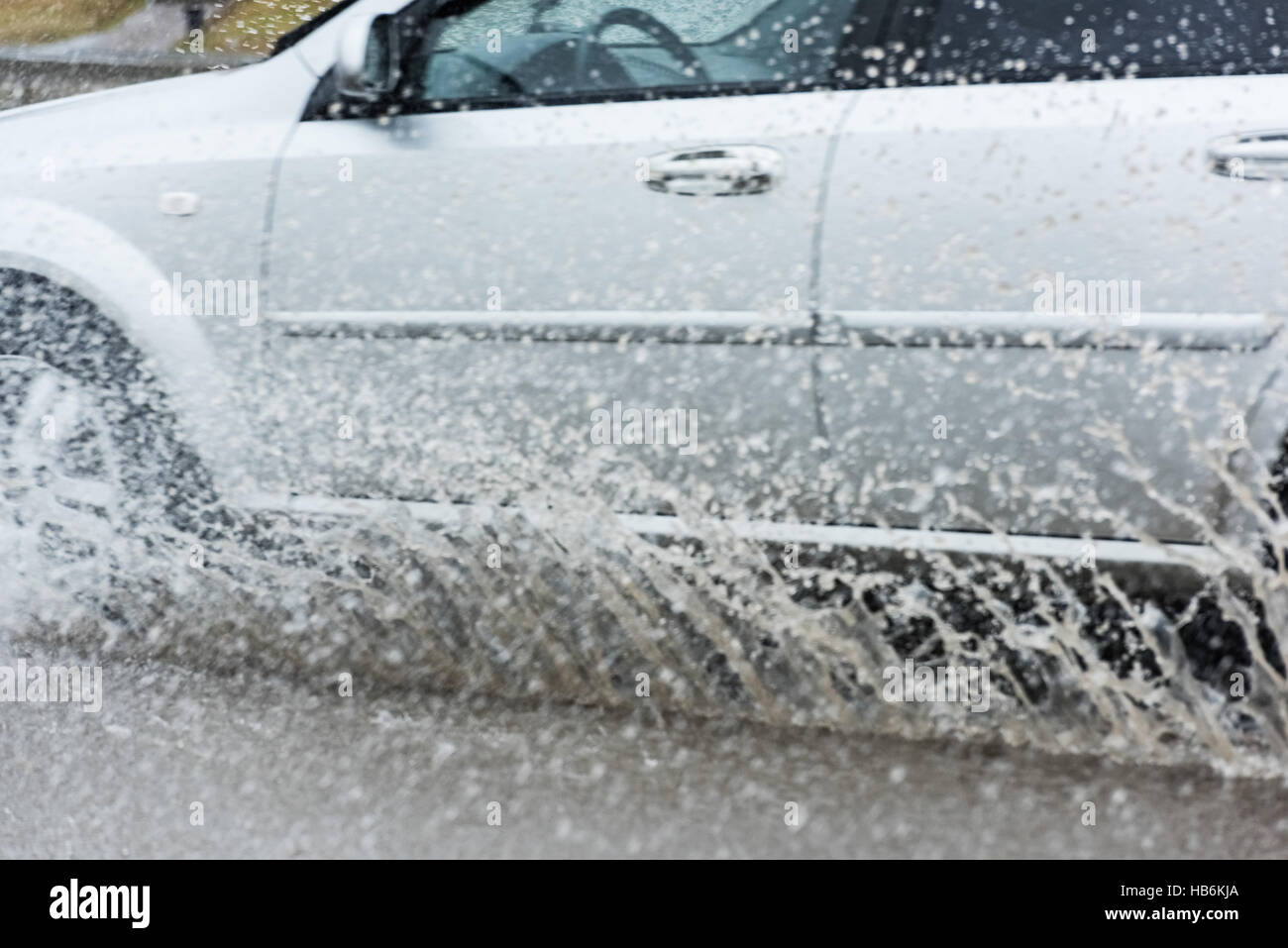 car rain puddle splashing water Stock Photo - Alamy