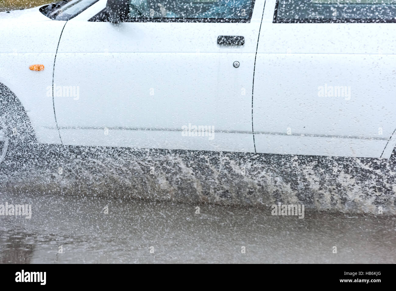 car rain puddle splashing water Stock Photo - Alamy