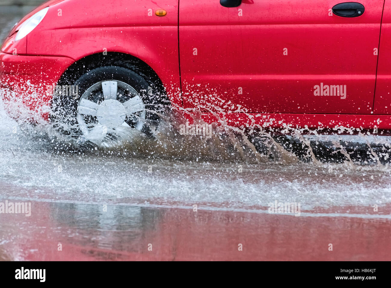 car rain puddle splashing water Stock Photo - Alamy