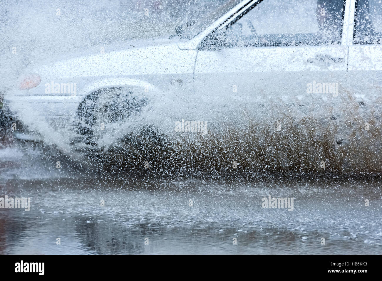 car rain puddle splashing water Stock Photo - Alamy