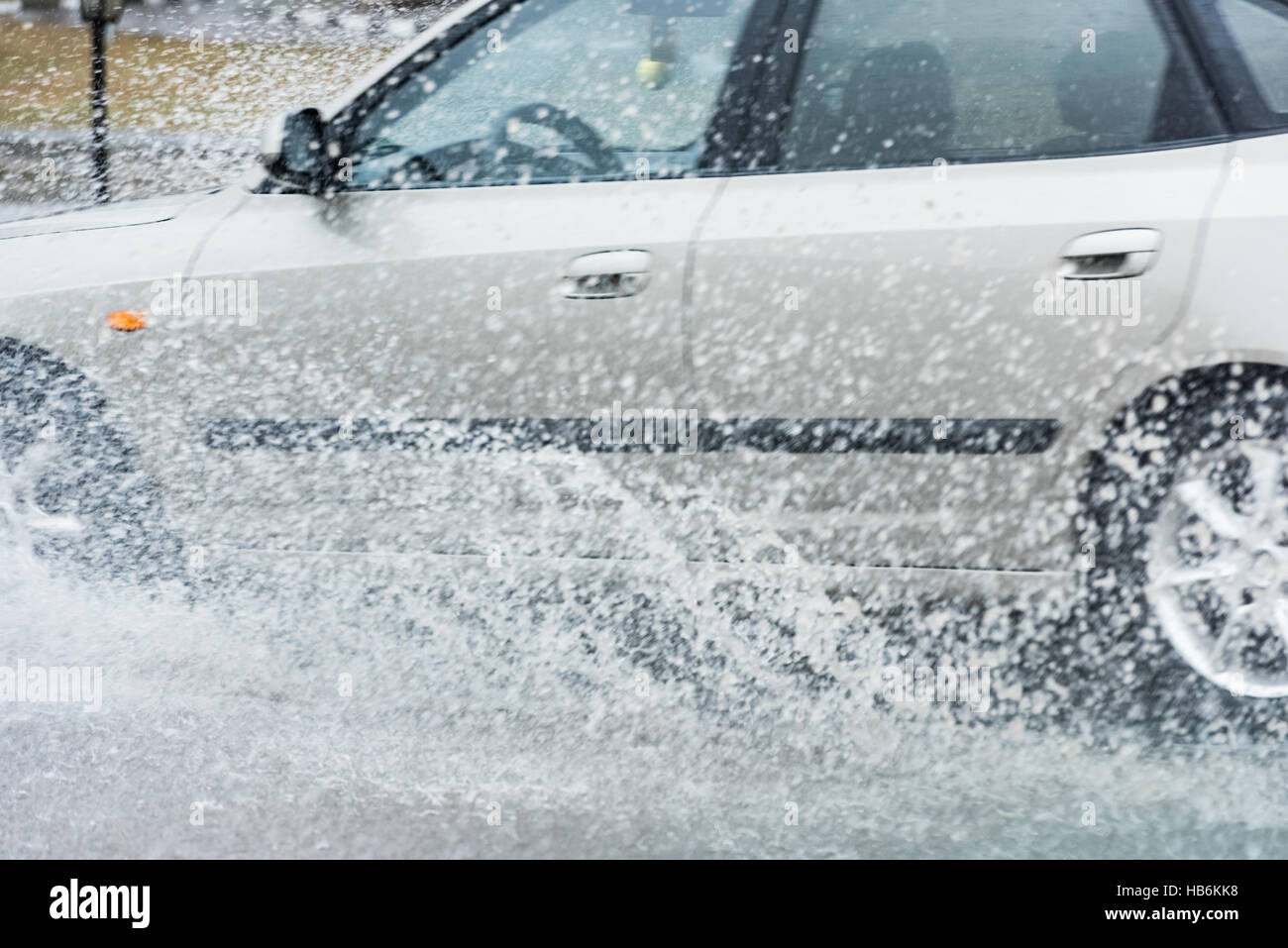 car rain puddle splashing water Stock Photo - Alamy