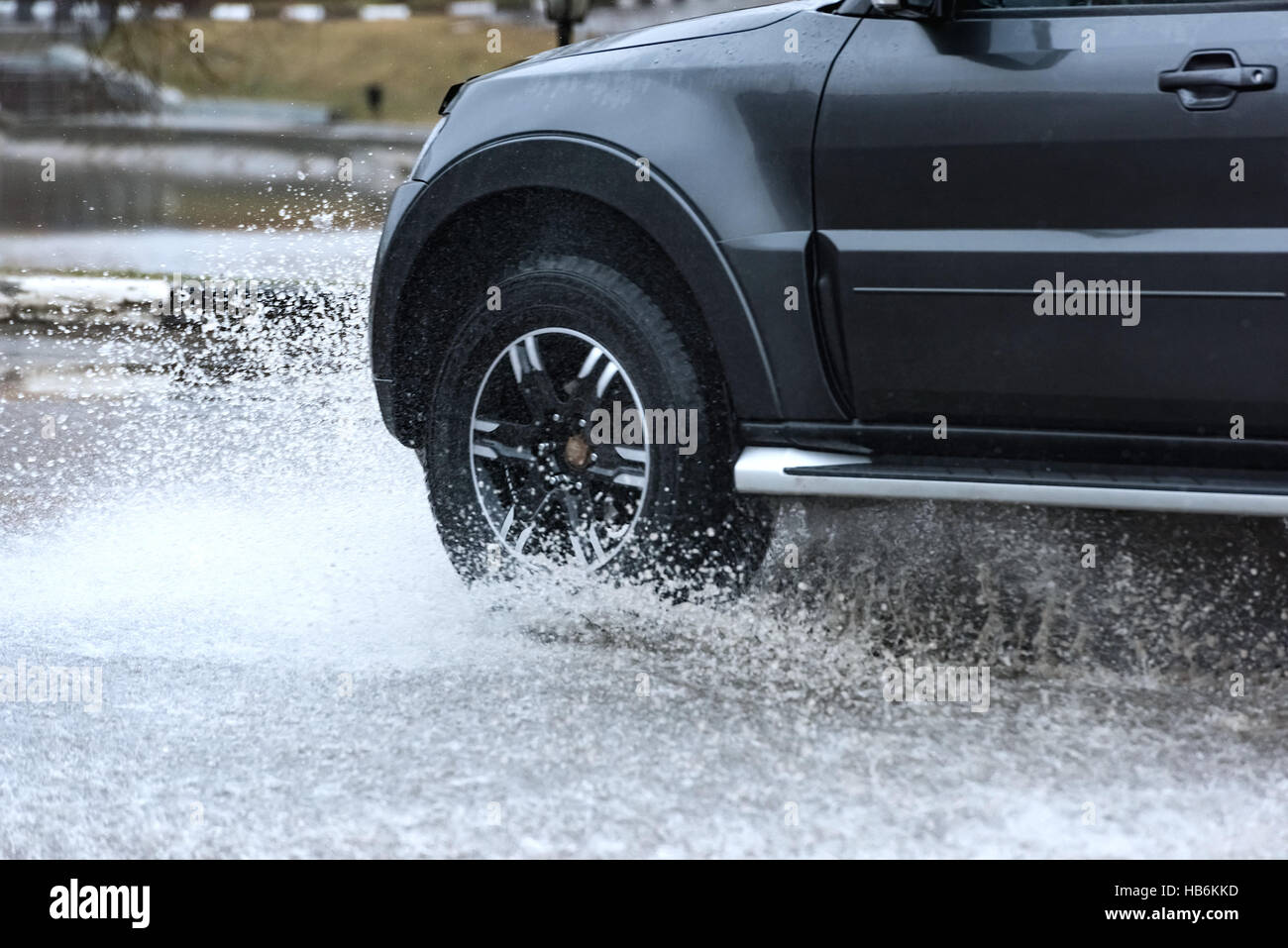 car rain puddle splashing water Stock Photo - Alamy