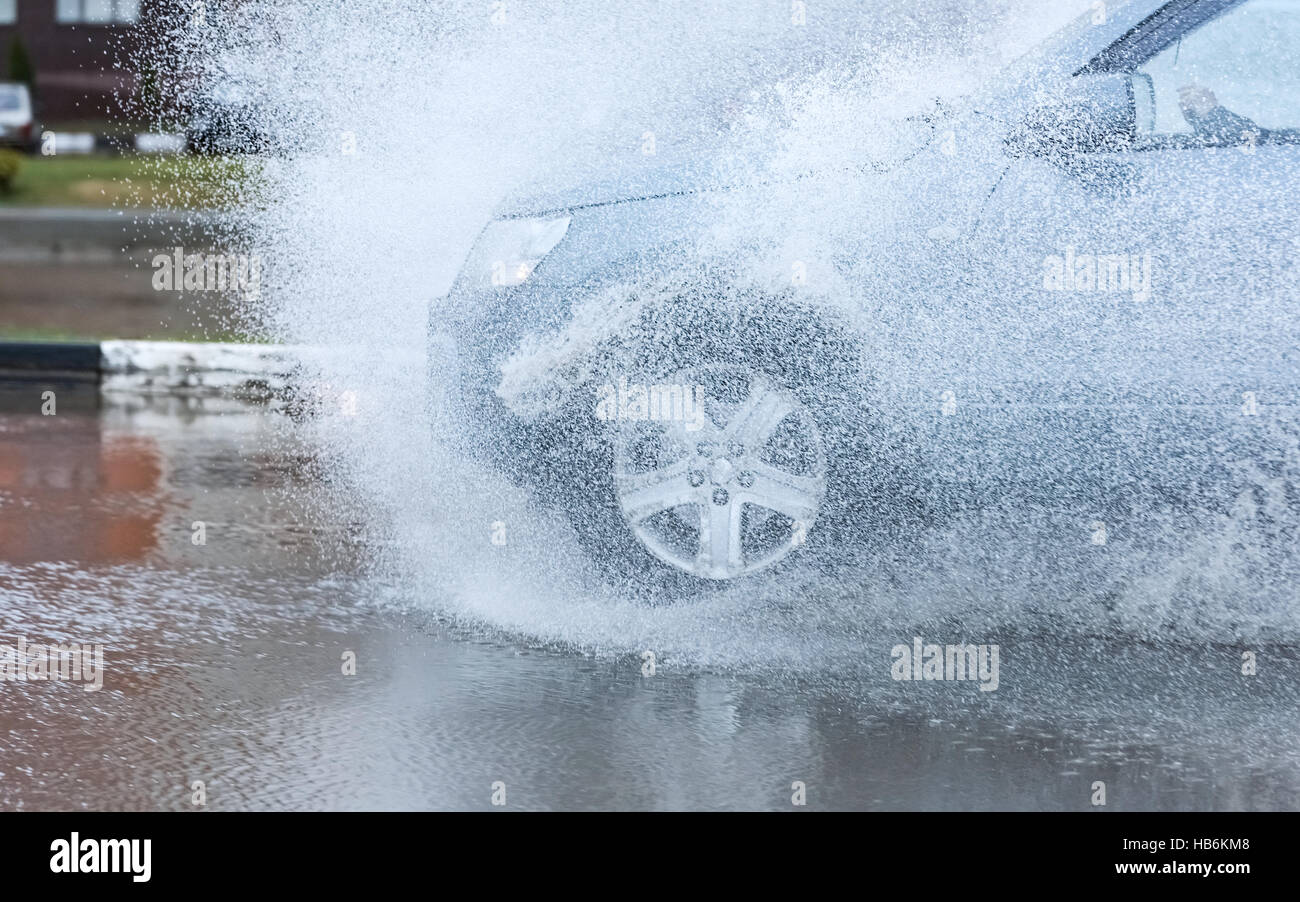 car rain puddle splashing water Stock Photo - Alamy