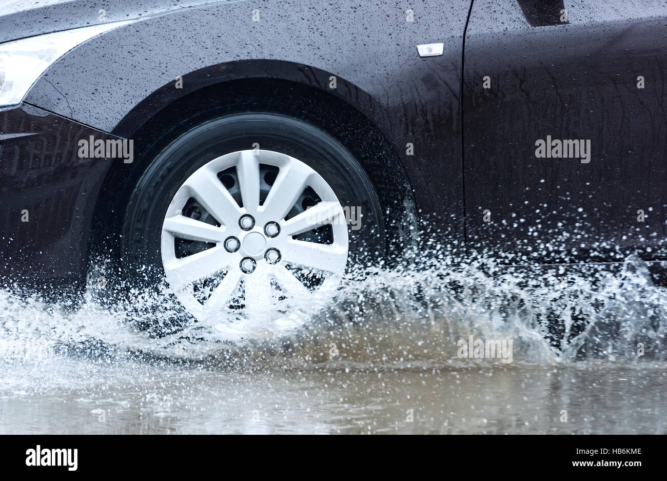 car rain puddle splashing water Stock Photo - Alamy