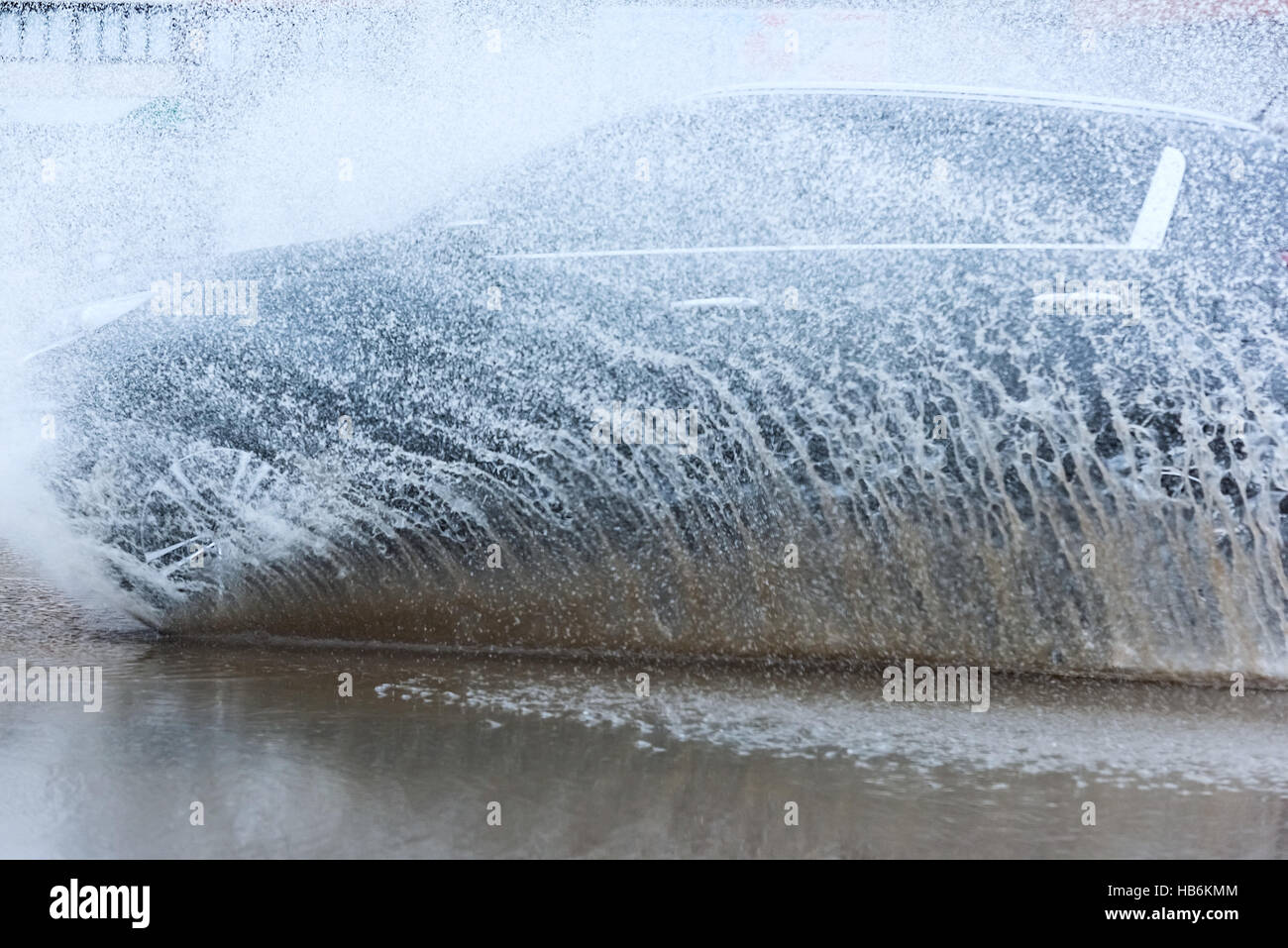 car rain puddle splashing water Stock Photo - Alamy