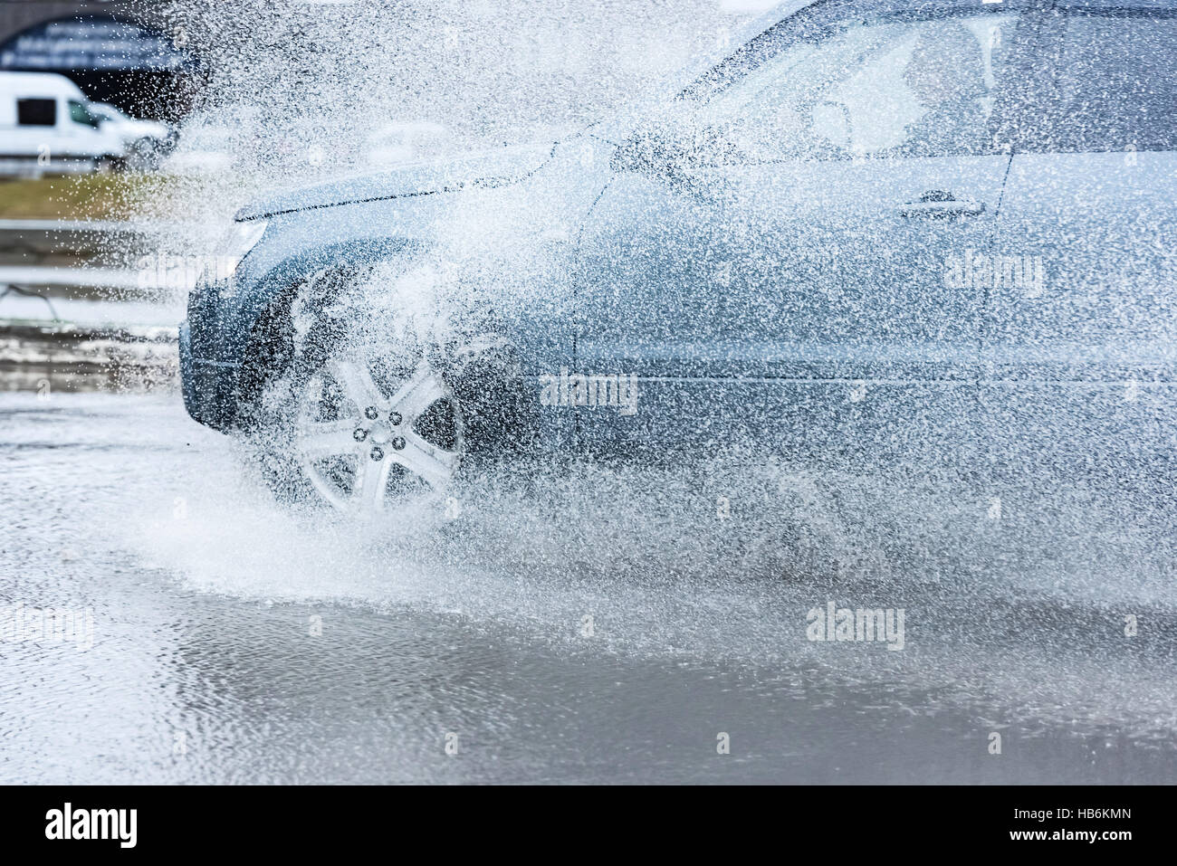 car rain puddle splashing water Stock Photo - Alamy