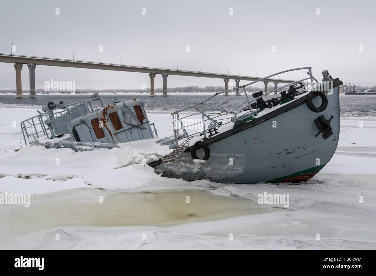 Sinking boat in a frozen river Stock Photo - Alamy
